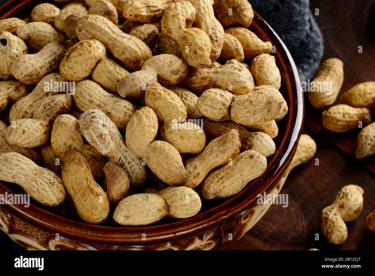 Peanuts in a bowl on a dark background. Peanuts in a shell. Healthy ...