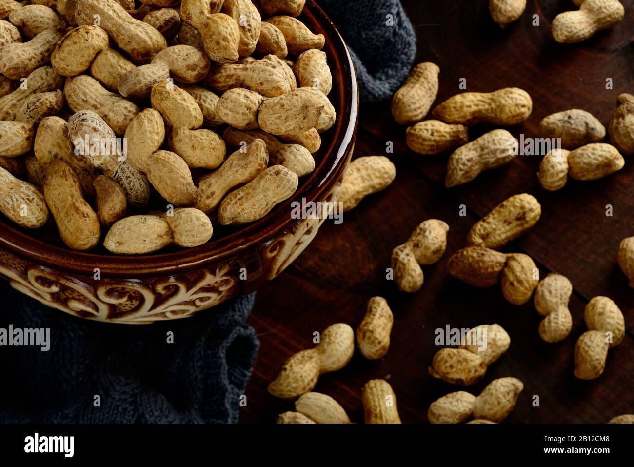 Peanuts in a bowl on a dark background. Peanuts in a shell. Healthy ...