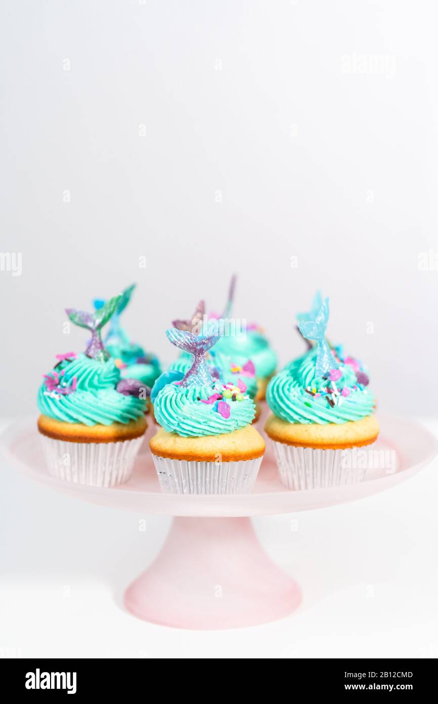 Gourmet mermaid cupcakes topped with blue buttercream frosting and ...