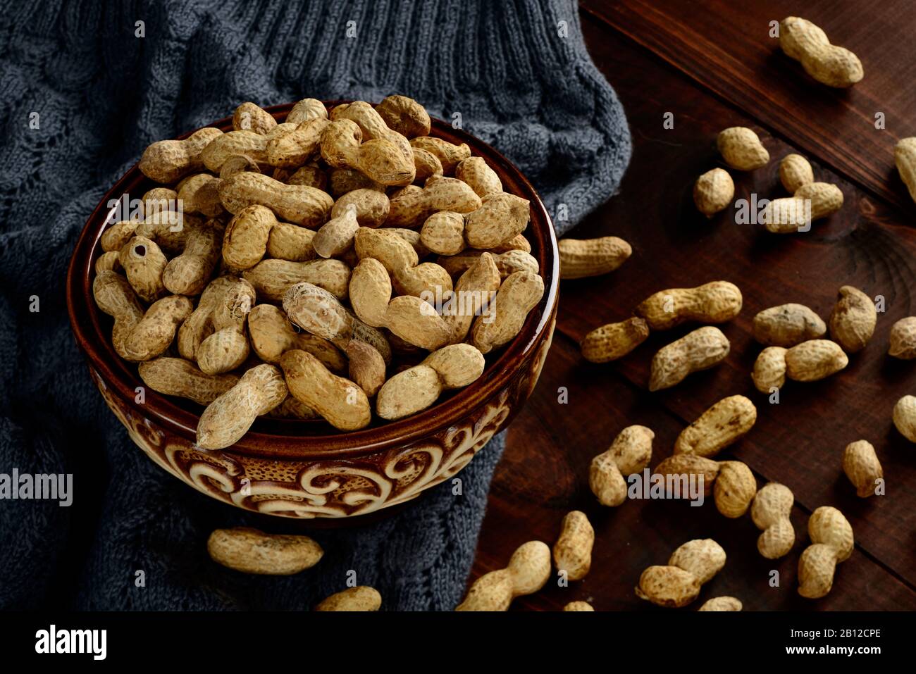 Peanuts in a bowl on a dark background. Peanuts in a shell. Healthy ...