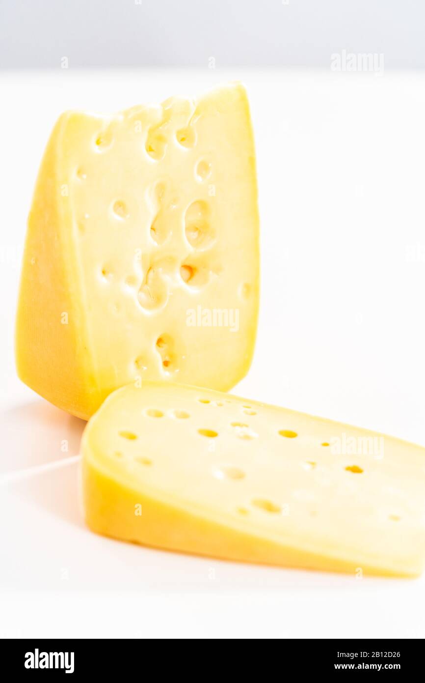 Large slice of semi soft part skim cheese on a white background Stock ...
