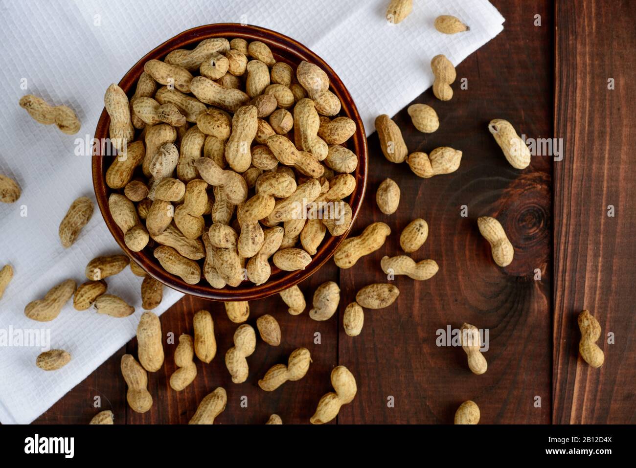 Peanuts in a bowl on a dark background. Peanuts in a shell. Healthy ...
