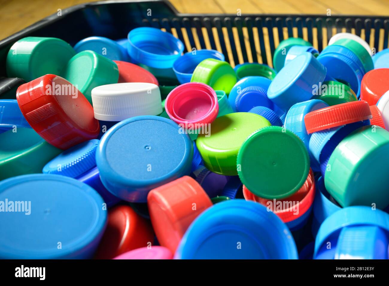 Various size and color plastic pills bottle caps inside crate Stock ...