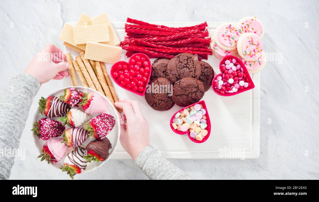 Flat lay. Step by step. Cheese board with candies and cookies for ...