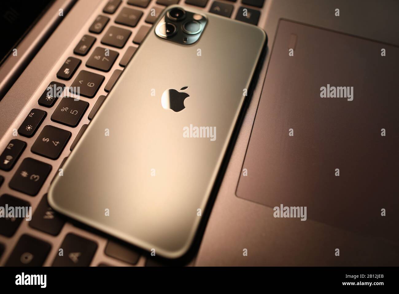 Apple iphone pro on laptop keyboard Stock Photo - Alamy