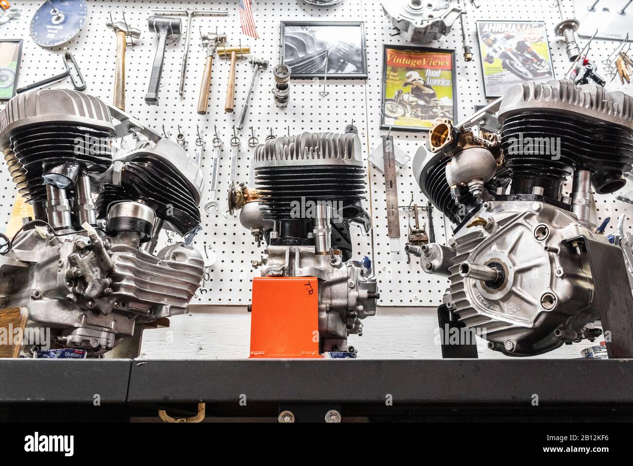 Three vintage Harley Davidson engines on display in a garage Stock ...