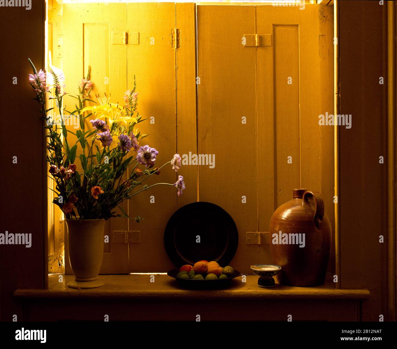 Closed yellow painted window shutters Stock Photo - Alamy