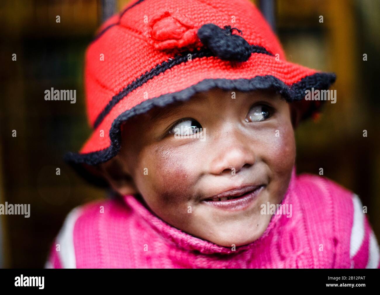 Portrait of a Tibetan kid in the cold with his cheeks reddened by the ...