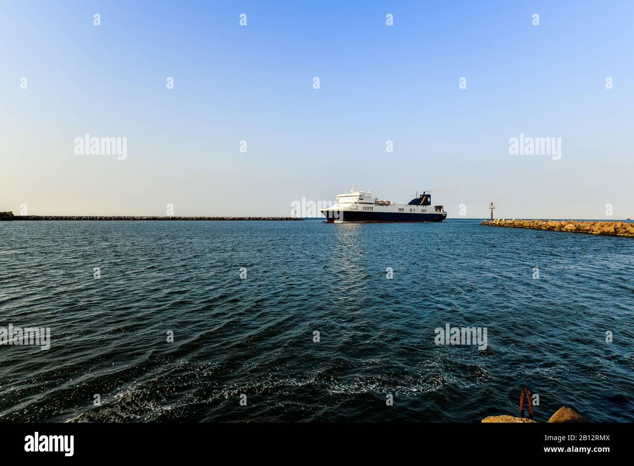 A cargo ship entering in the post of Klaipeda Stock Photo - Alamy