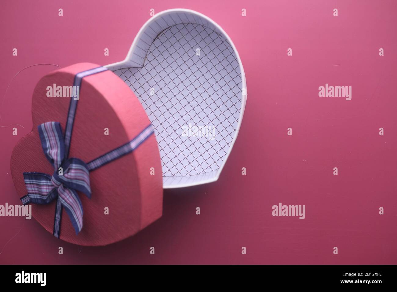 top view of empty heart shape gift box on red background Stock Photo ...