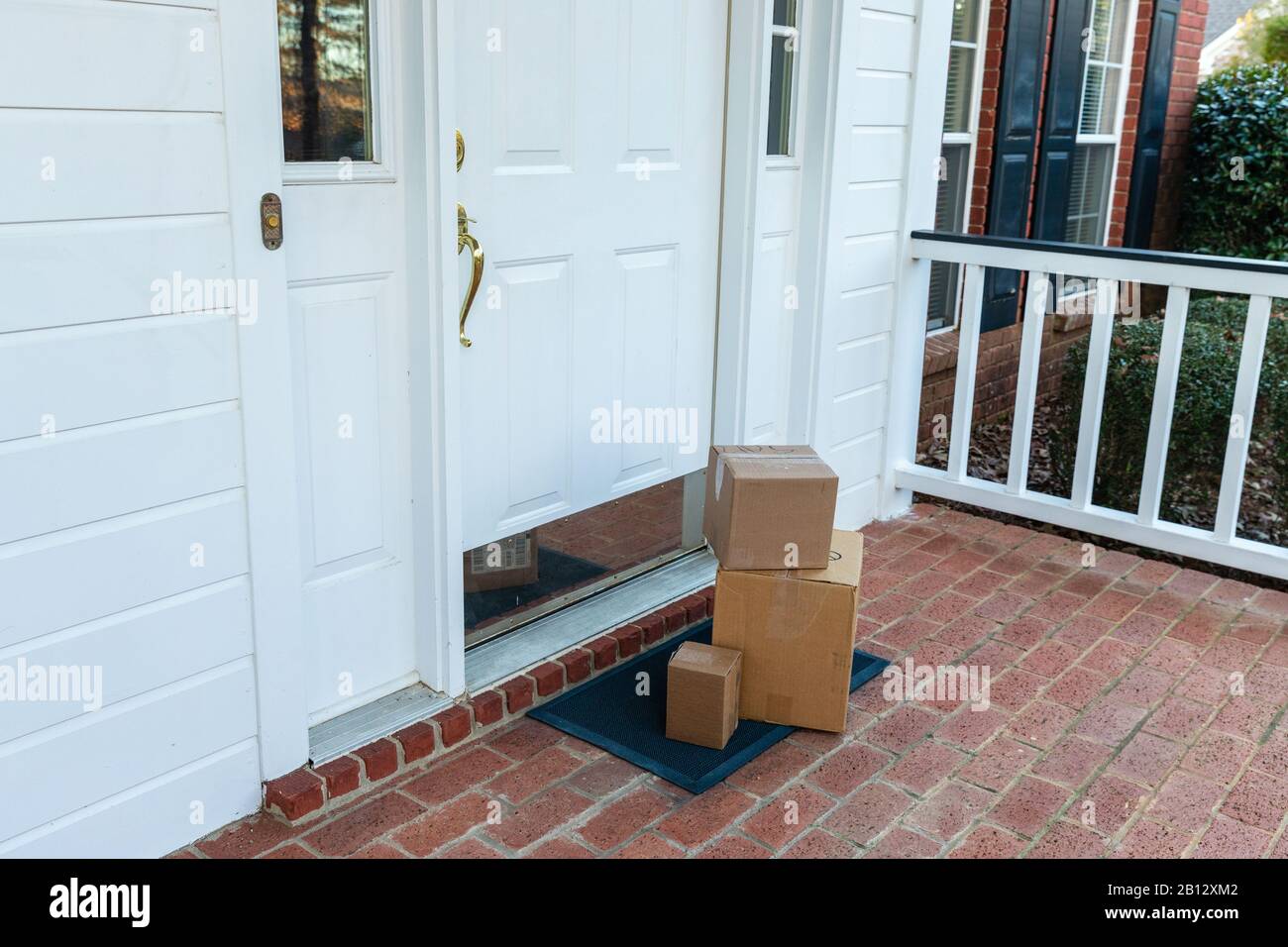 Shipping boxes on front porch of home Stock Photo - Alamy