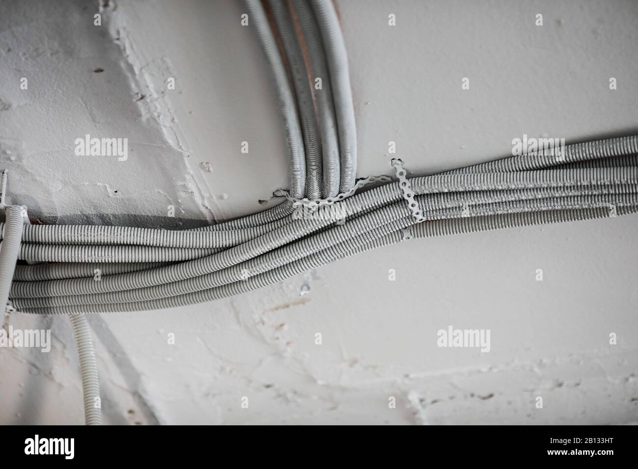 Electricity cables in an unfinished building on a construction site ...