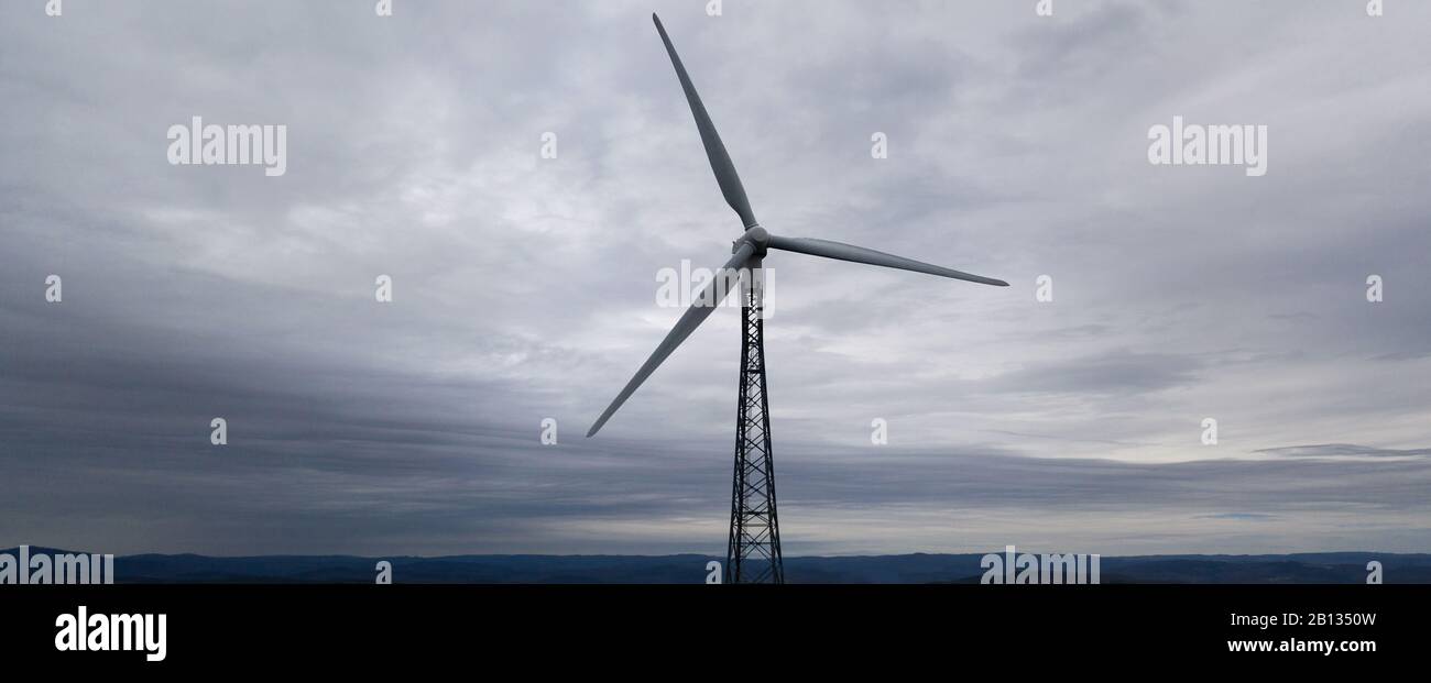 wind wheel in front a dark cloudscape panorama Stock Photo - Alamy