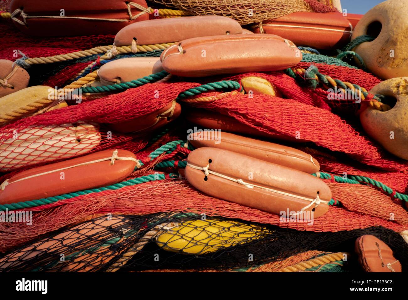 colourful fishing net floats lie on a moored fishing boat in Sri Lanka ...