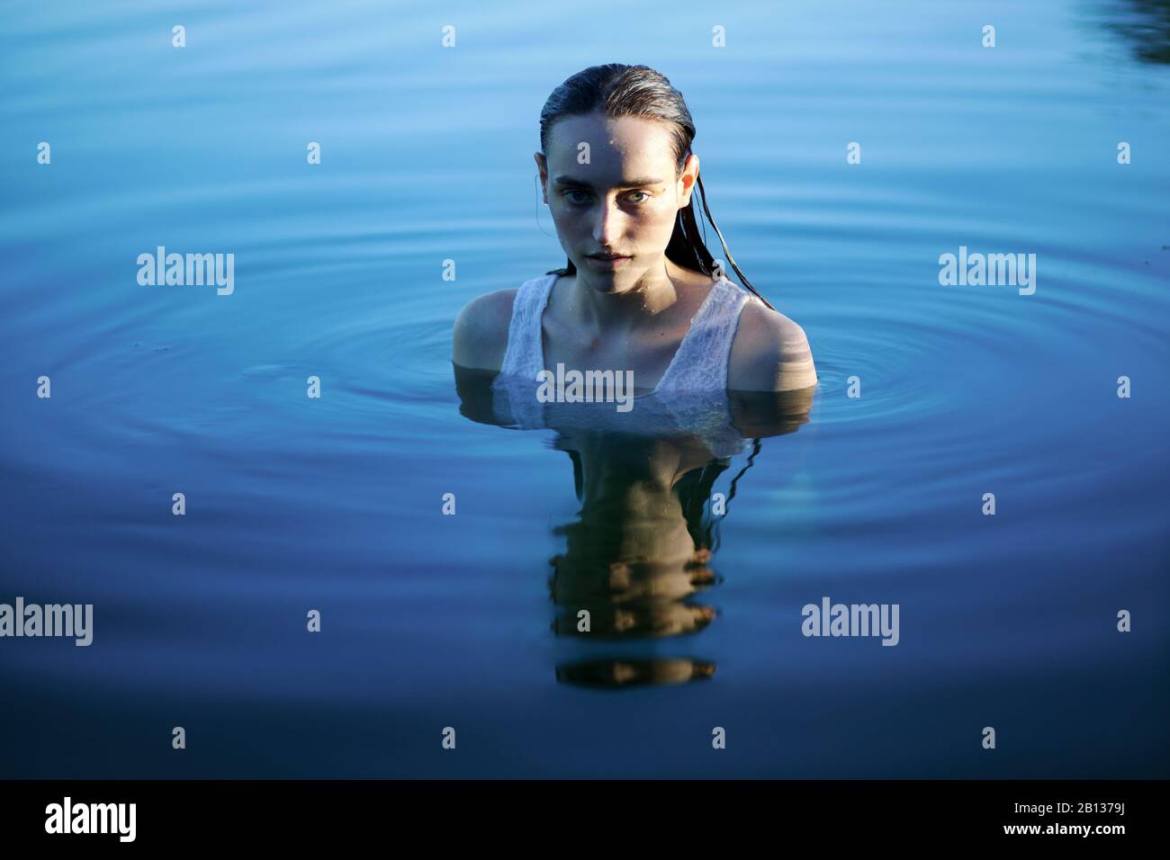 Young woman standing in water,portrait Stock Photo - Alamy