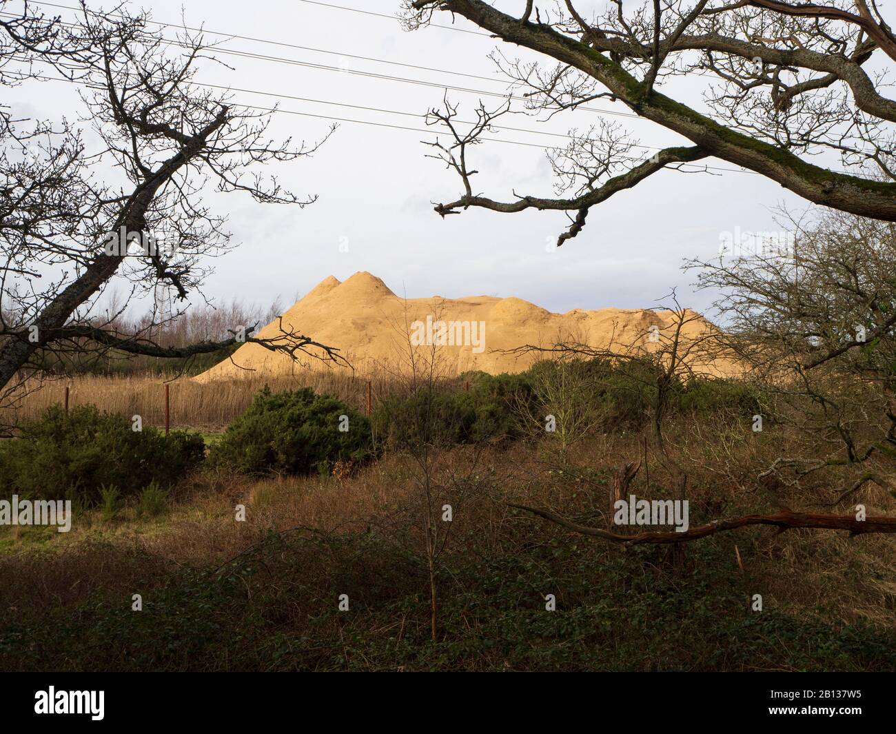 Man made mounds of earth in rural setting Stock Photo - Alamy