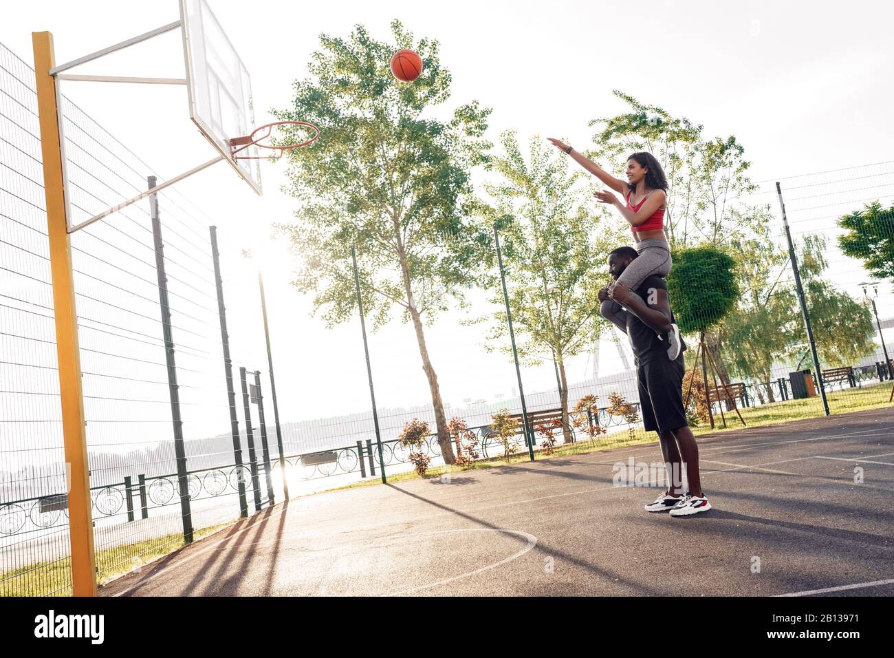 Outdoors Activity. Girlfriend sitting on shoulders of boyfriend ...