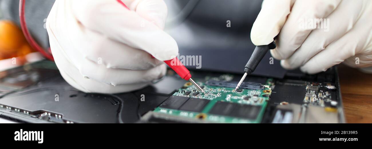 Technician soldering laptop parts Stock Photo - Alamy