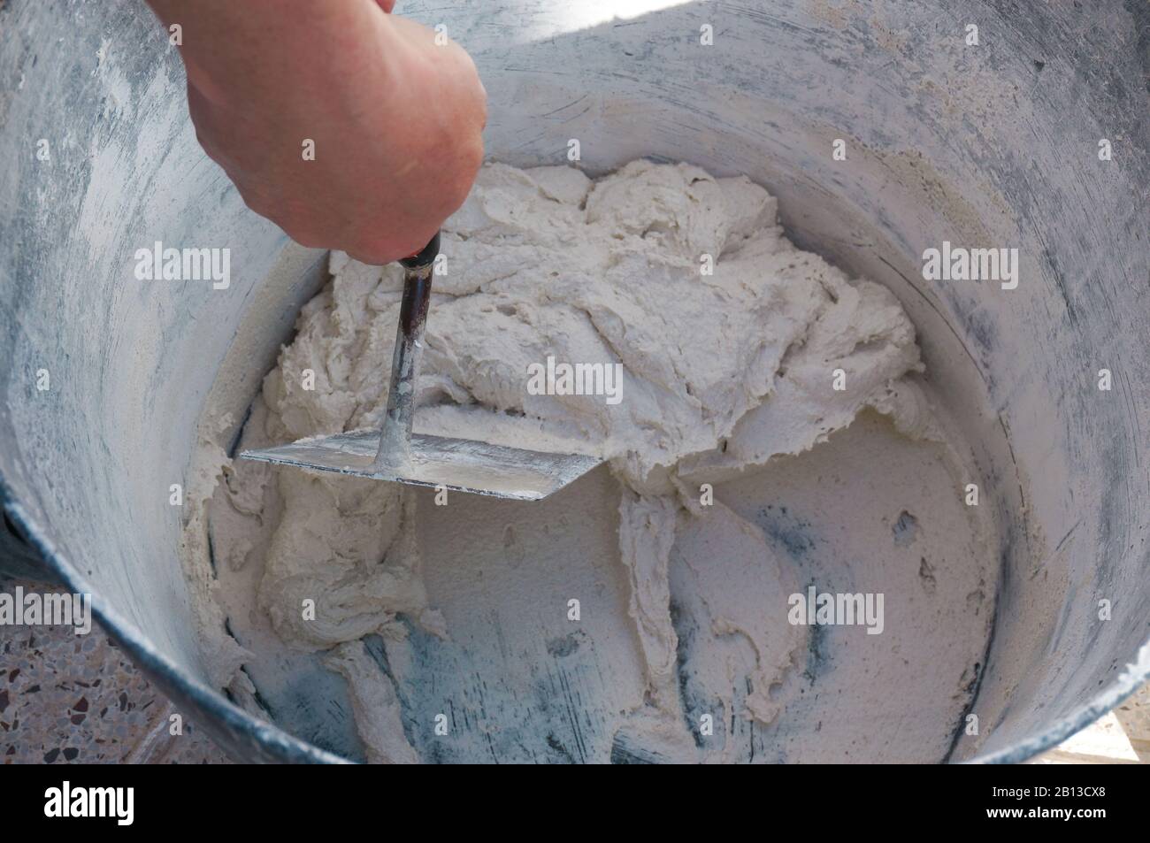 Hand moving soft cement mixture construction instrument Stock Photo - Alamy