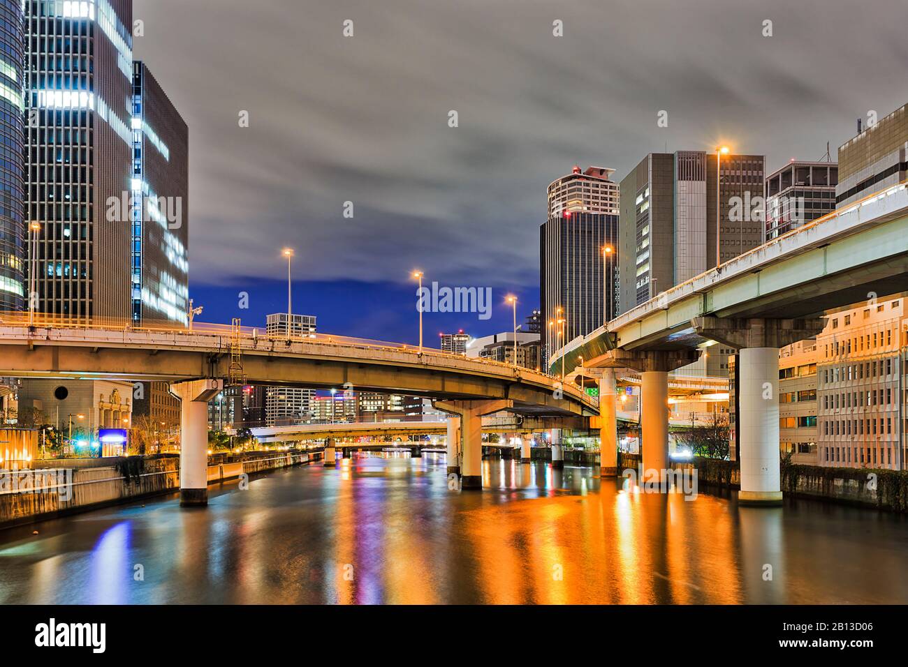 Highway bridges crossing over Osaka city rive at sunrise between high ...