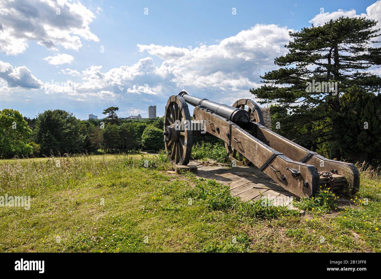 Replica cannon on the earthworks at Basing House with the buildings of ...
