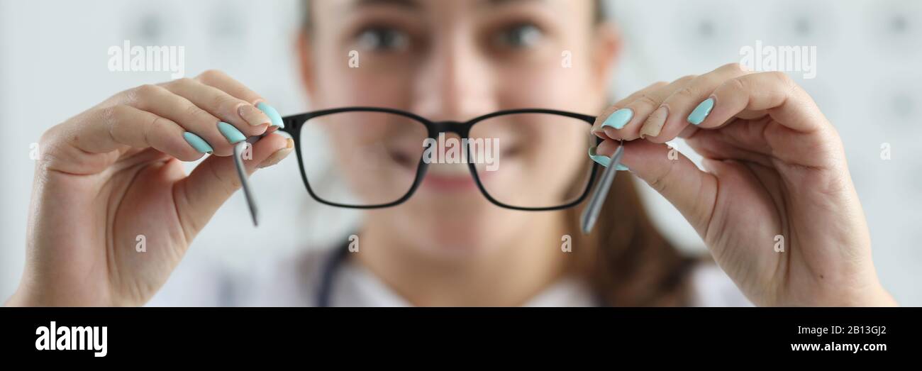 Happy female performing eyesight check Stock Photo - Alamy