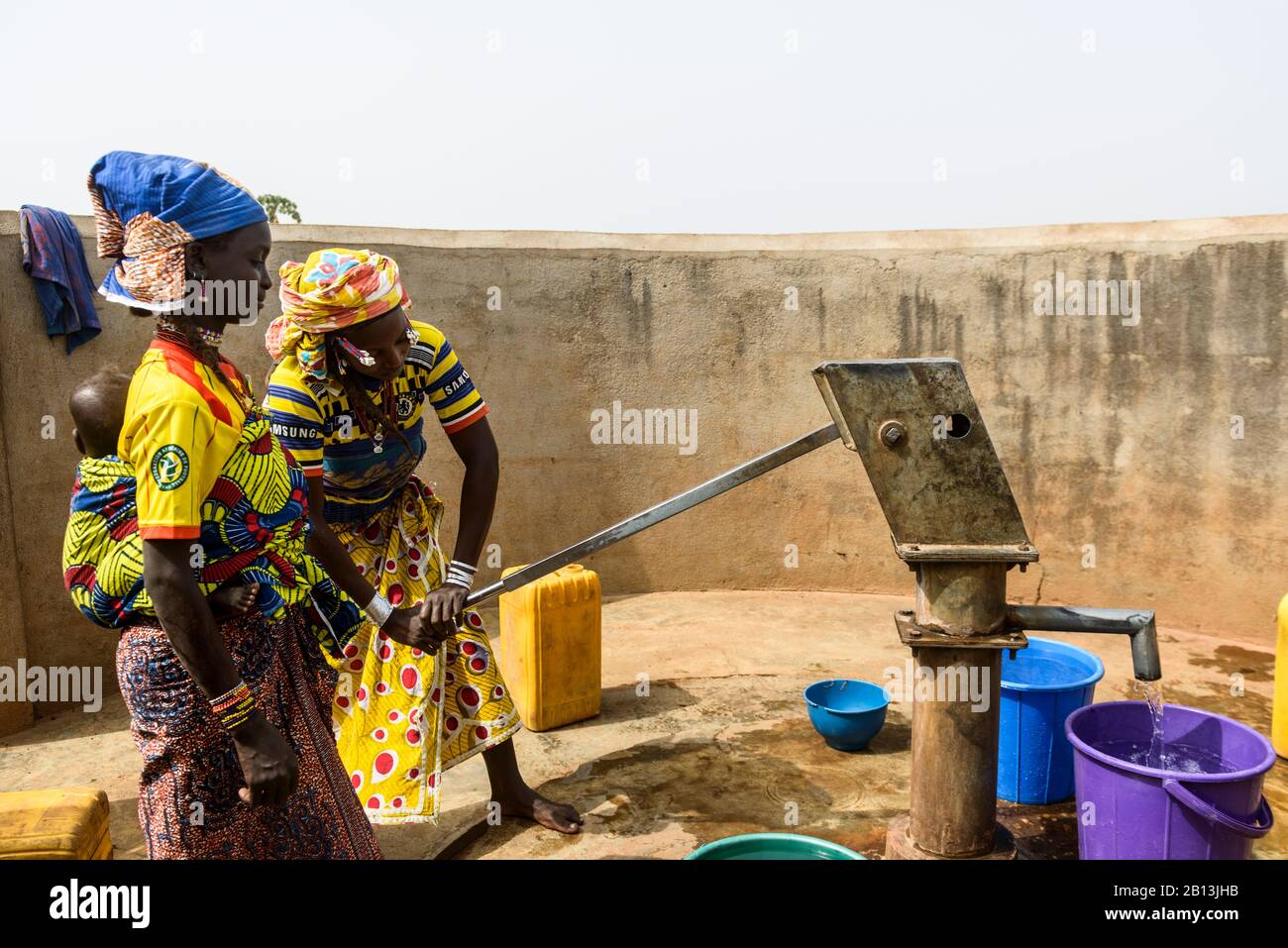 Fulani women getting water at the water pump,Northern Togo Stock Photo ...