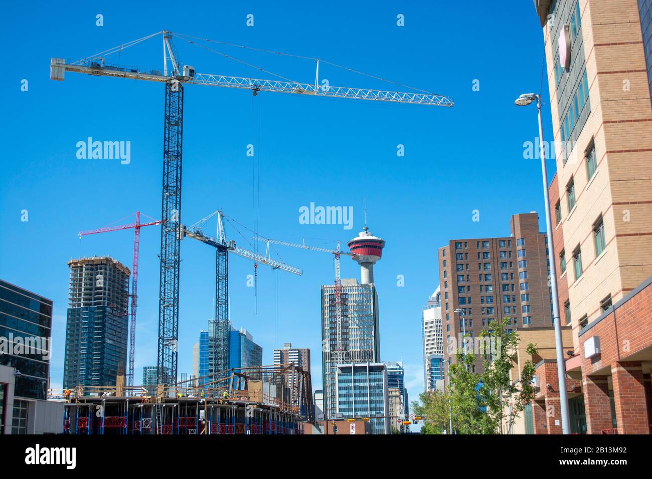 Modern building under construction in downtown with tower in background ...