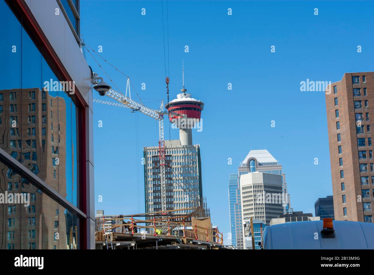 Modern building under construction in downtown with tower in background ...