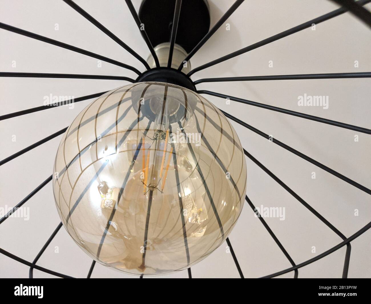 Vintage Edison light bulb inside iron frame chandelier close up Stock ...