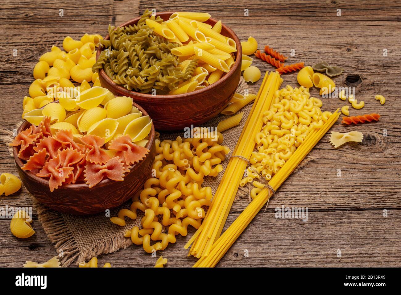 Different types of pasta in ceramic bowls. Traditional Italian food ...