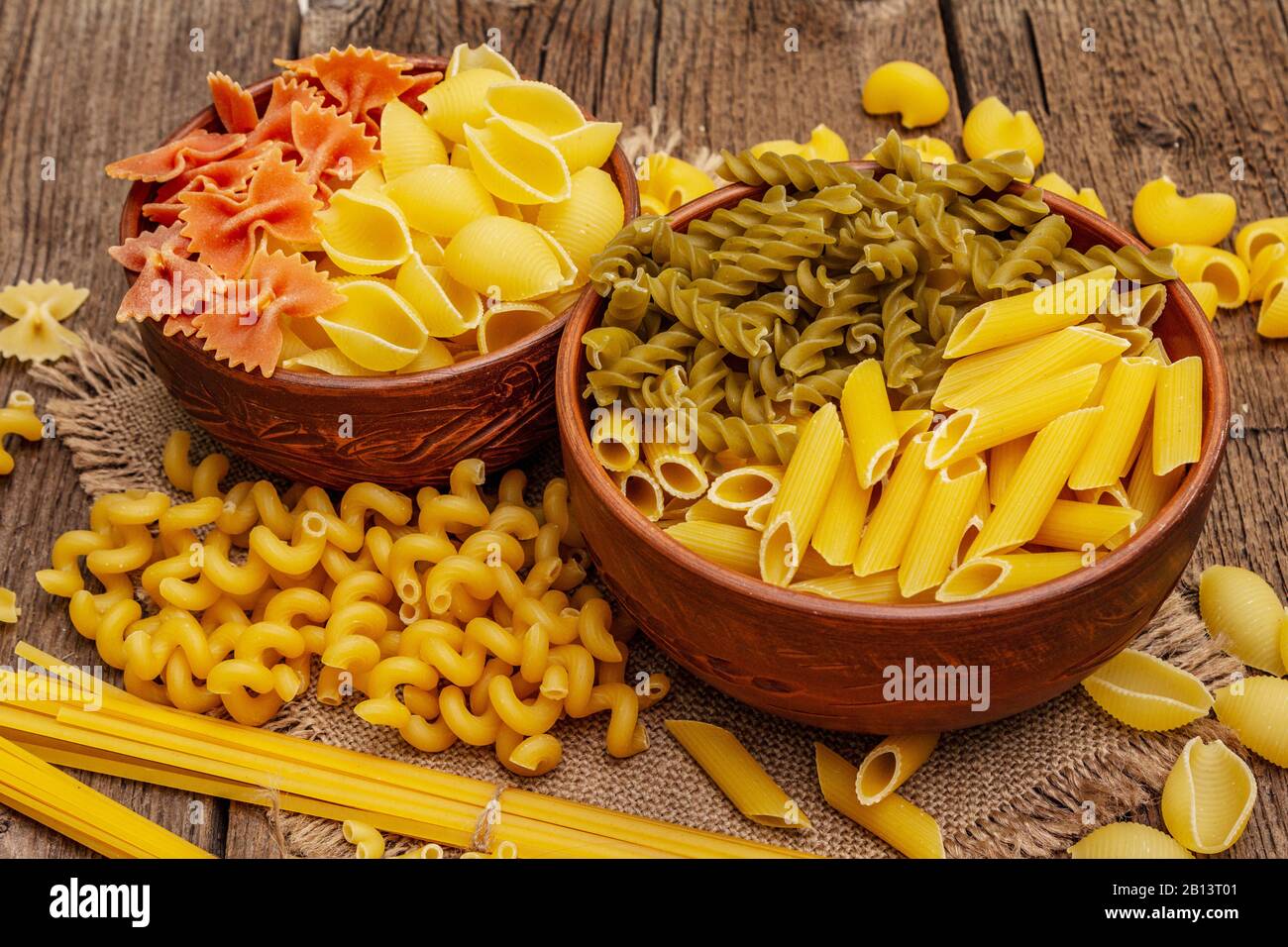 Different types of pasta in ceramic bowls. Traditional Italian food ...