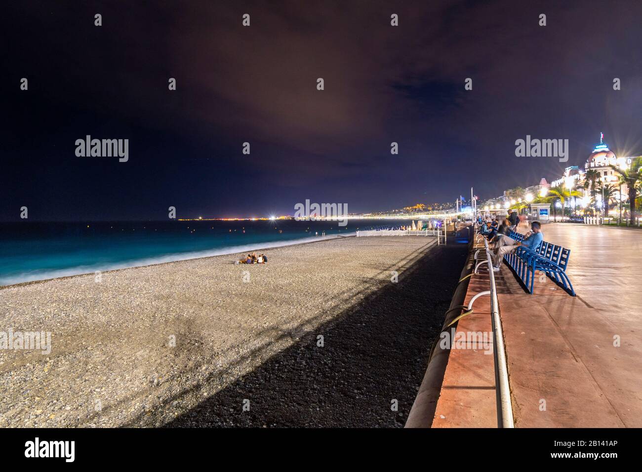 Night time shot along the Promenade des Anglais as tourists enjoy an ...