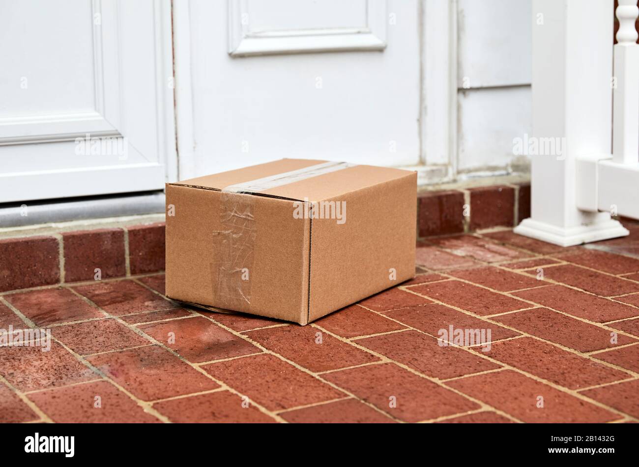 Cardboard box delivered to front door Stock Photo - Alamy