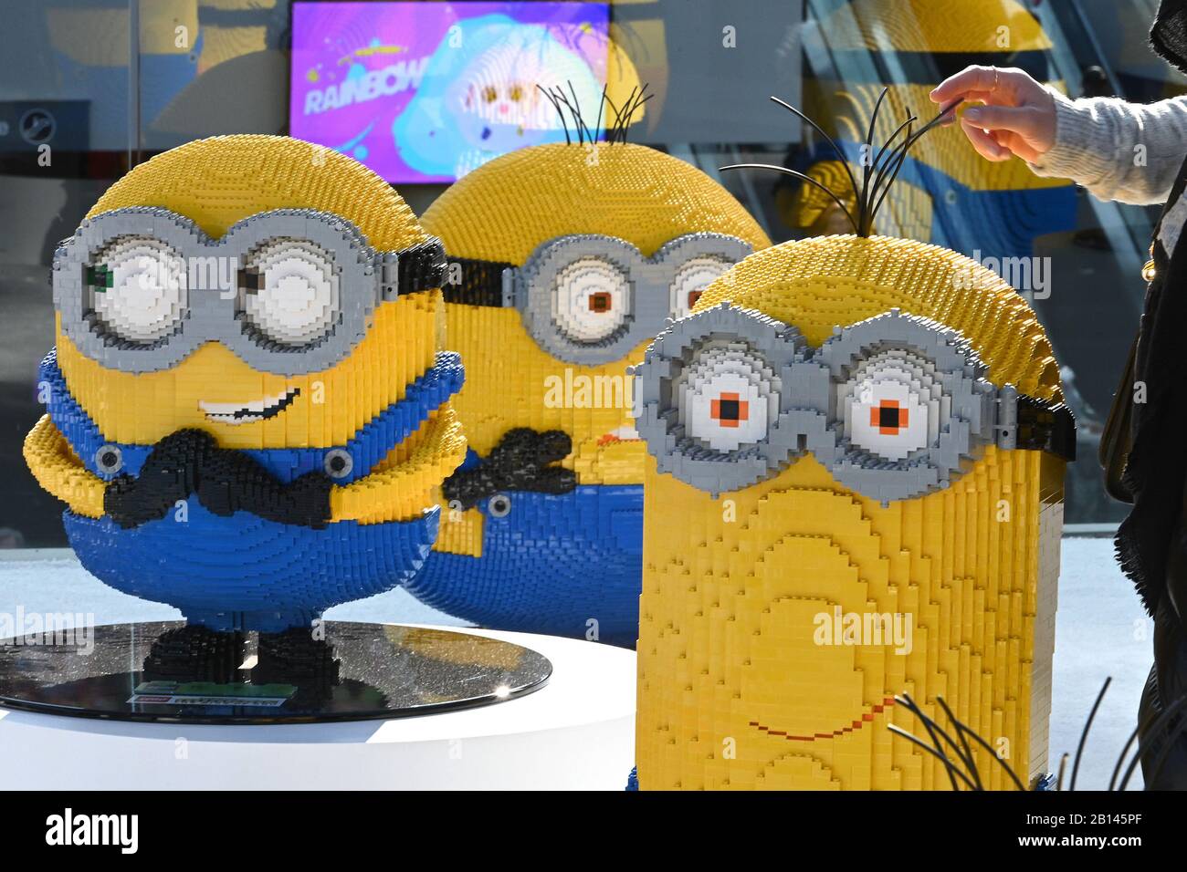 A woman touches a lego display for the promotion of “Minions: The Ris ...