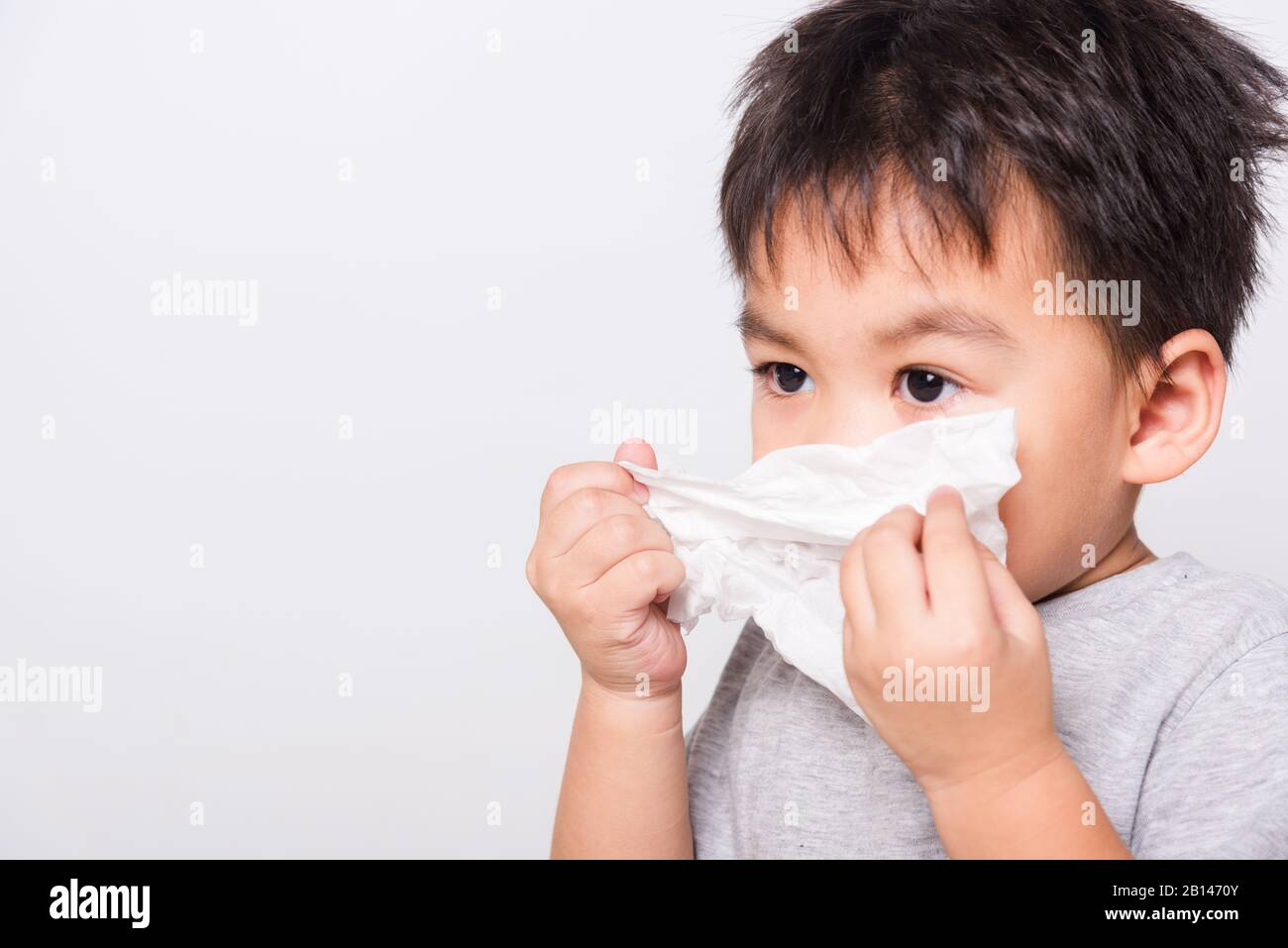 Closeup Asian face, Little children boy cleaning nose with tissue on ...