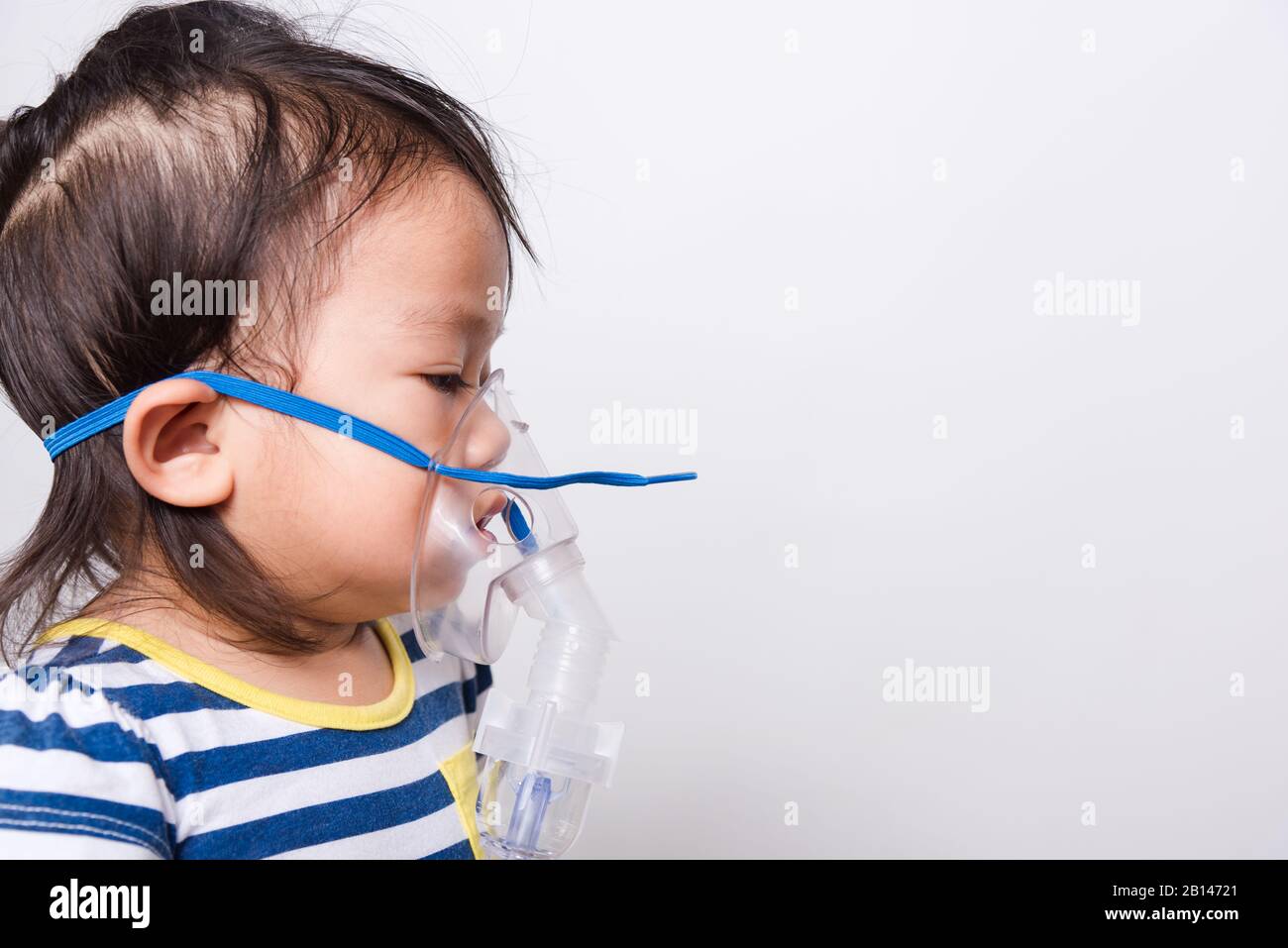 Closeup Asian face, Little baby girl sick her using steam inhaler ...