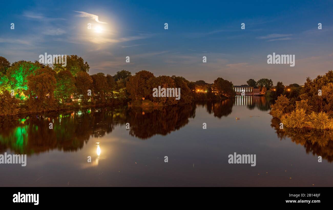 View over the river Ruhr at night with the old hydropower station in ...