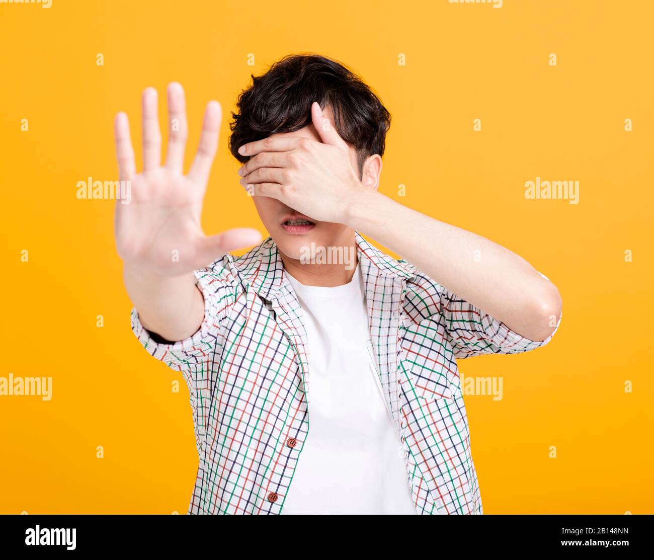 scared young man hand cover eyes with stop sign Stock Photo - Alamy