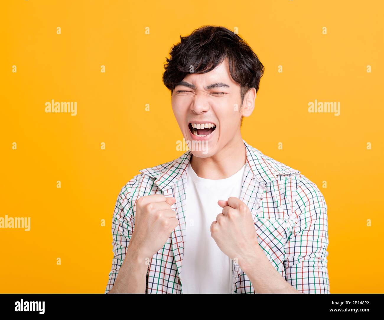 excited young man with yelling face Stock Photo - Alamy