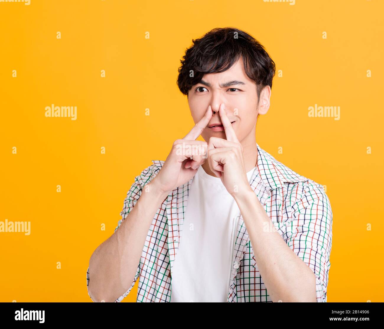 young man hand holding his nose Stock Photo - Alamy