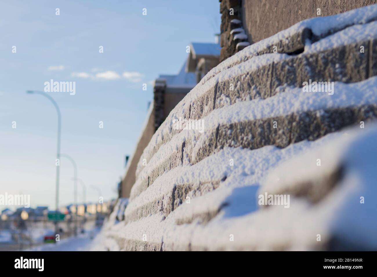 Retaining wall covered with layers of Snow in Winter Stock Photo - Alamy