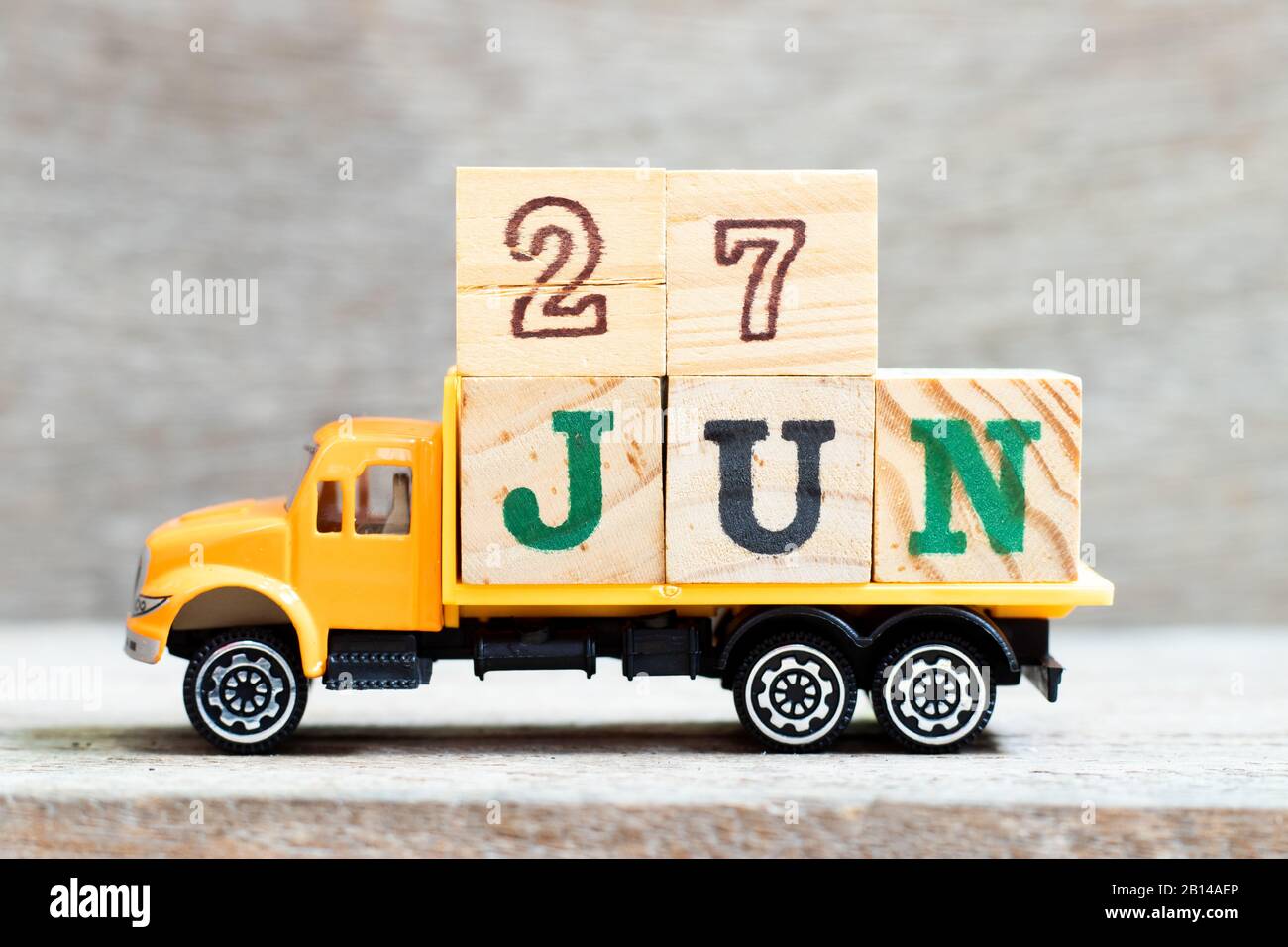 Truck hold letter block in word 27jun on wood background (Concept for ...