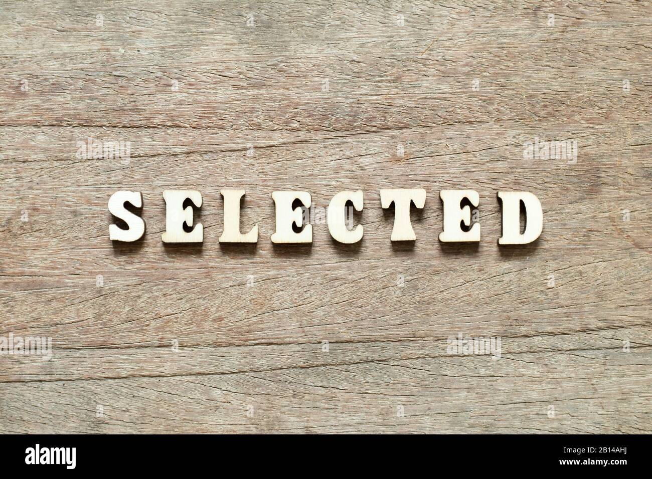Letter block in word selected on wood background Stock Photo - Alamy
