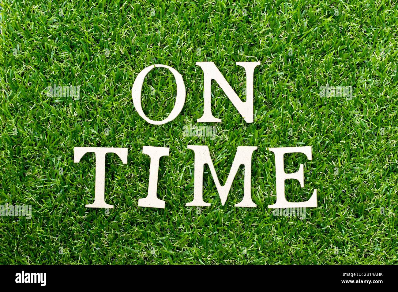 Wood alphabet letter in word on time on green grass background Stock ...