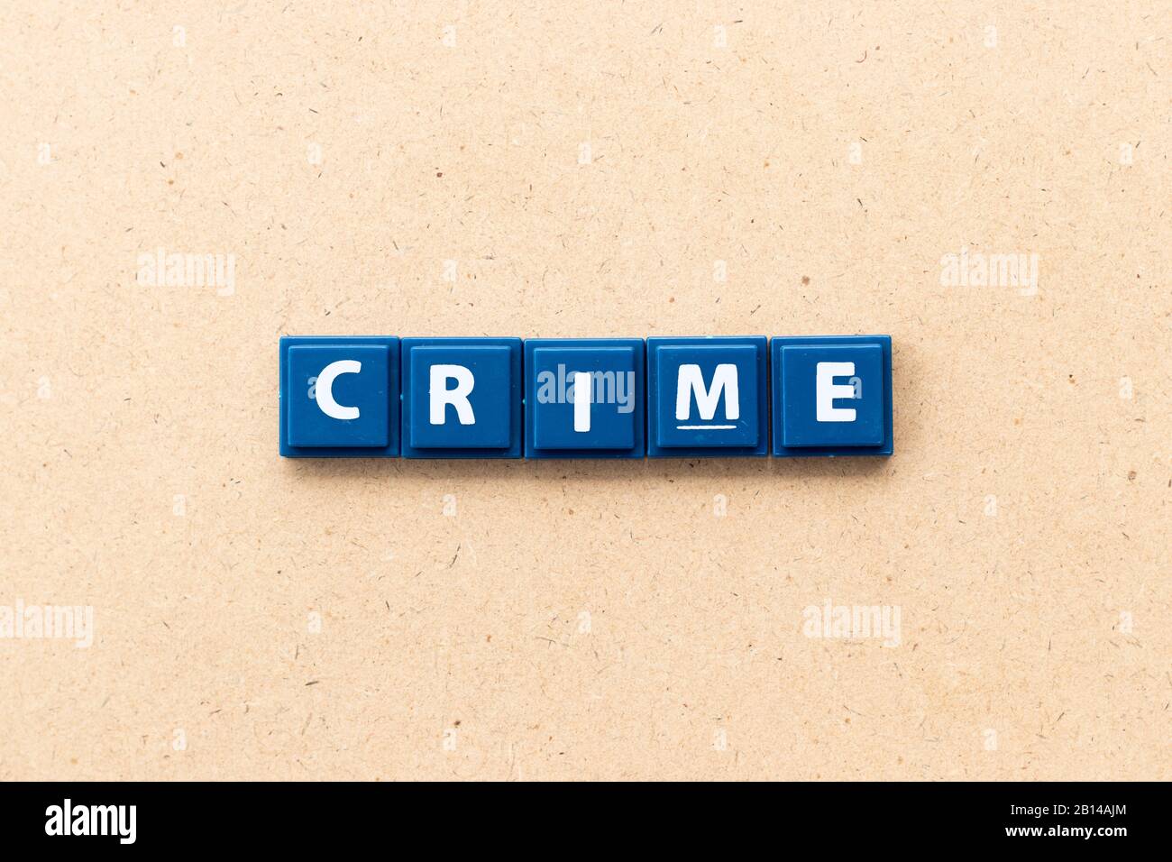Tile letter in word crime on wood background Stock Photo - Alamy