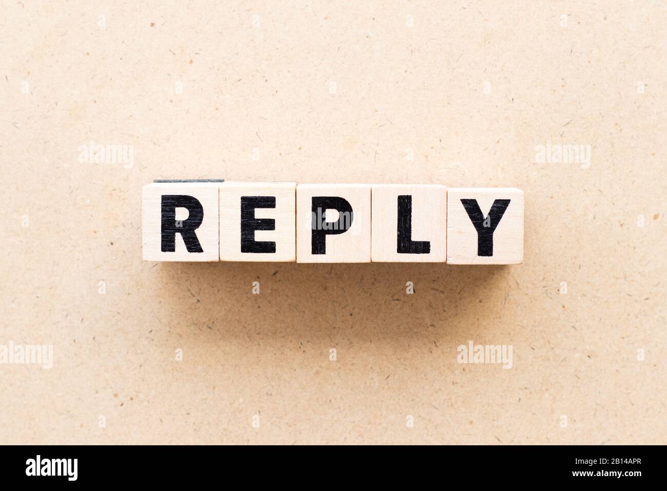 Letter block in word reply on wood background Stock Photo - Alamy