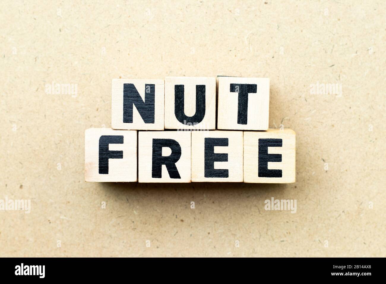 Letter block in word nut free on wood background Stock Photo - Alamy