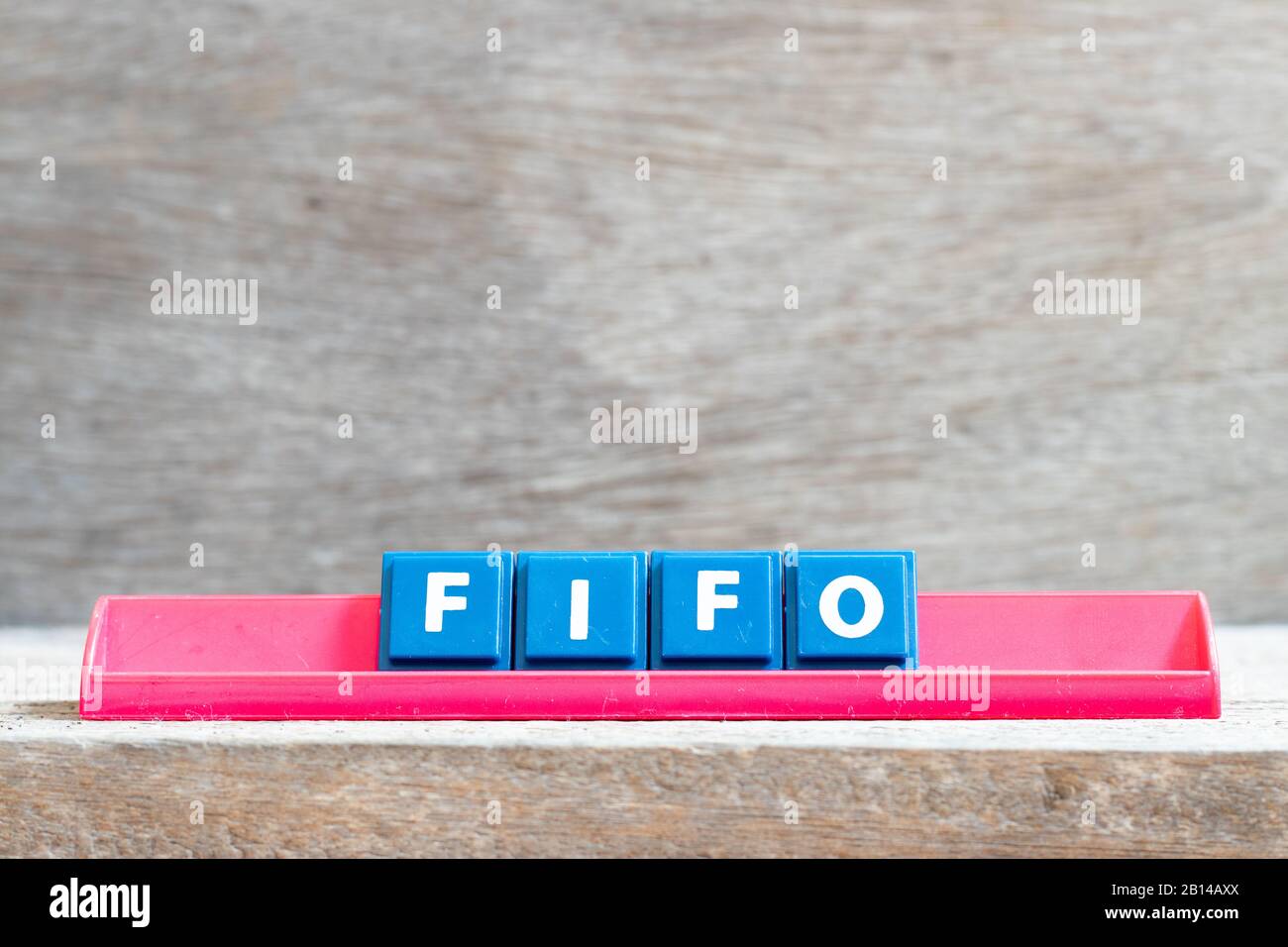 Tile letter on red rack in word FIFO (Abbreviation of first in first ...