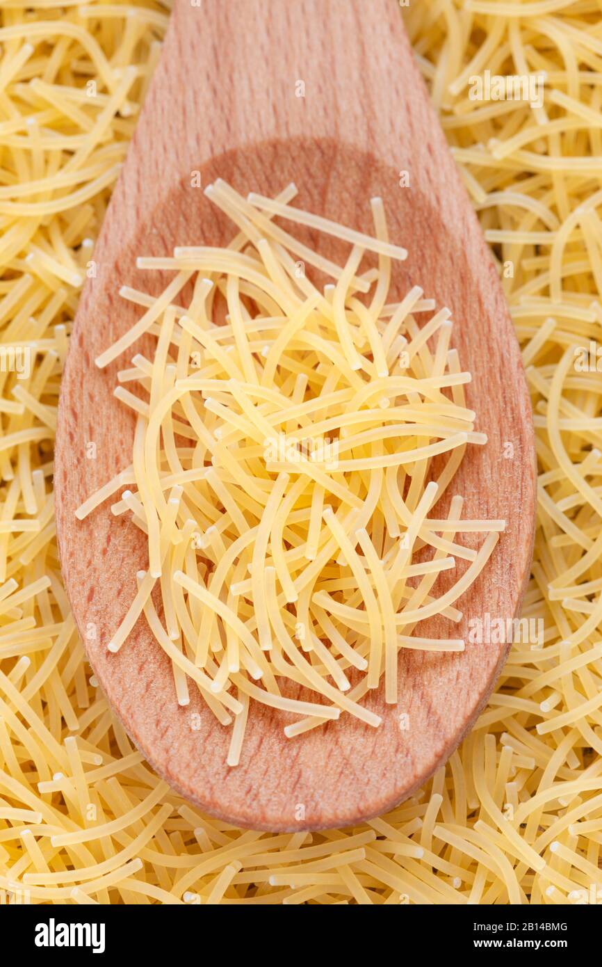 Small vermicelli in wooden spoon background full frame Stock Photo - Alamy